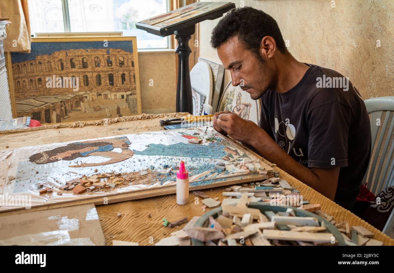 An artist, with an image of the famous Roman amphitheatre behind, works ...