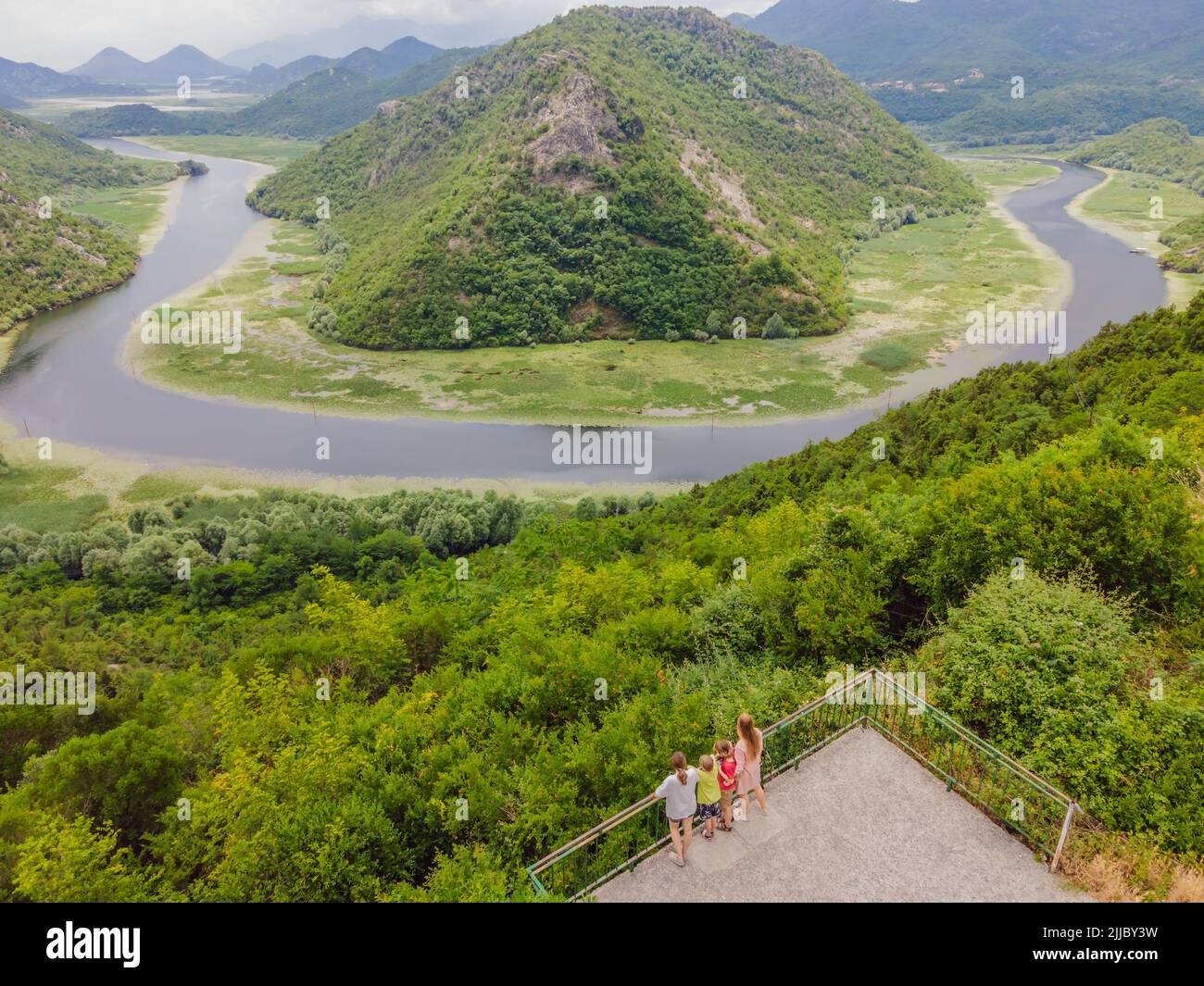 Tourists in the background Canyon of Rijeka Crnojevica river near the Skadar lake coast. One of ...