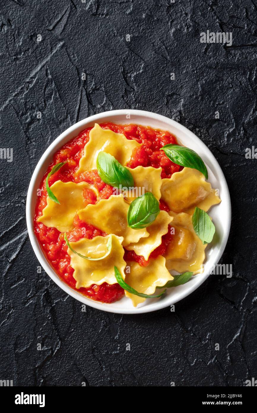 Ravioli with tomato sauce and fresh basil, Italian dumplings, top shot ...