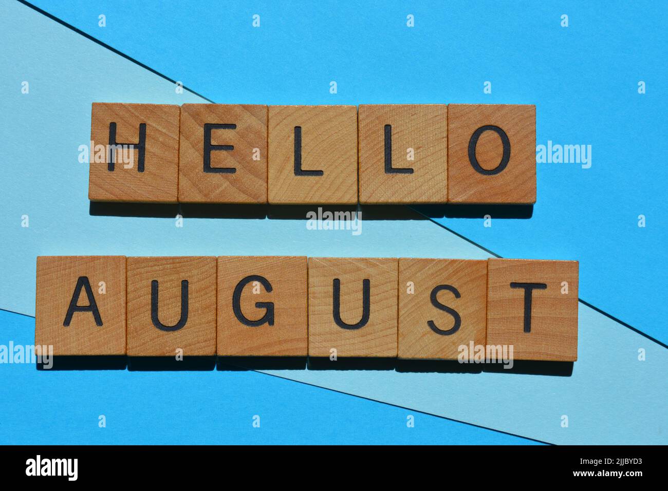 Hello August, words in wood alphabet letters isolated on blu background ...