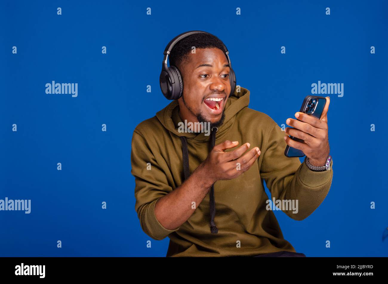 Cheerful African American man using mobile phone application Stock ...