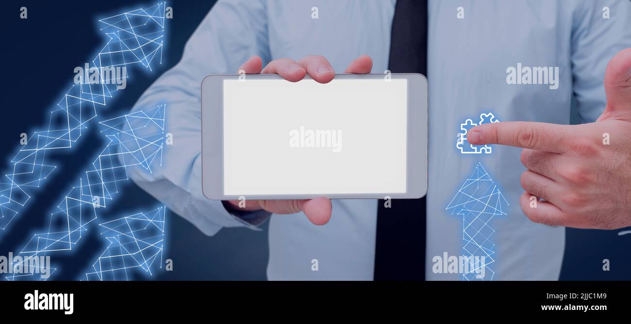 Businessman Holding A Touch Screen And Pointing On A Jigsaw With ...