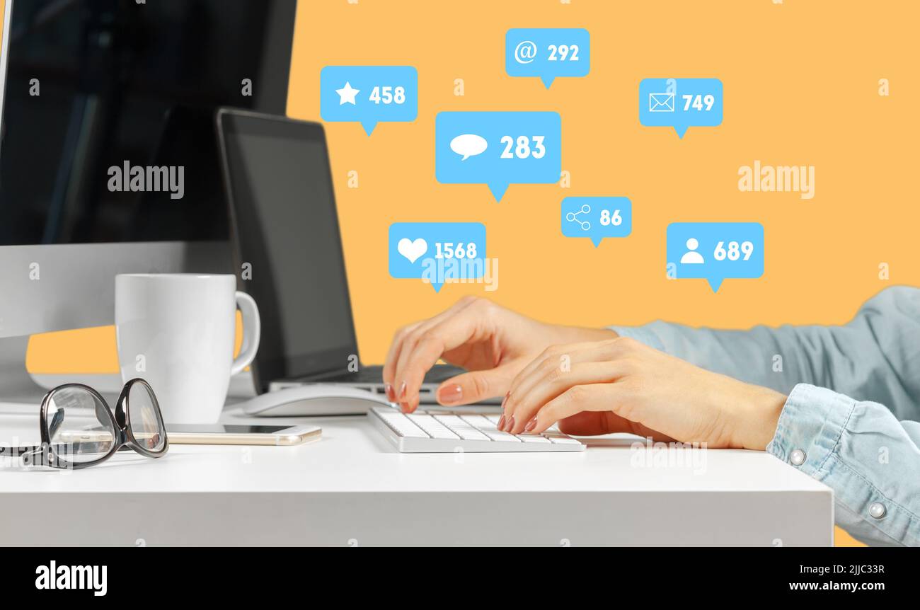 Young woman sitting at the table with open netbook computer. Female ...