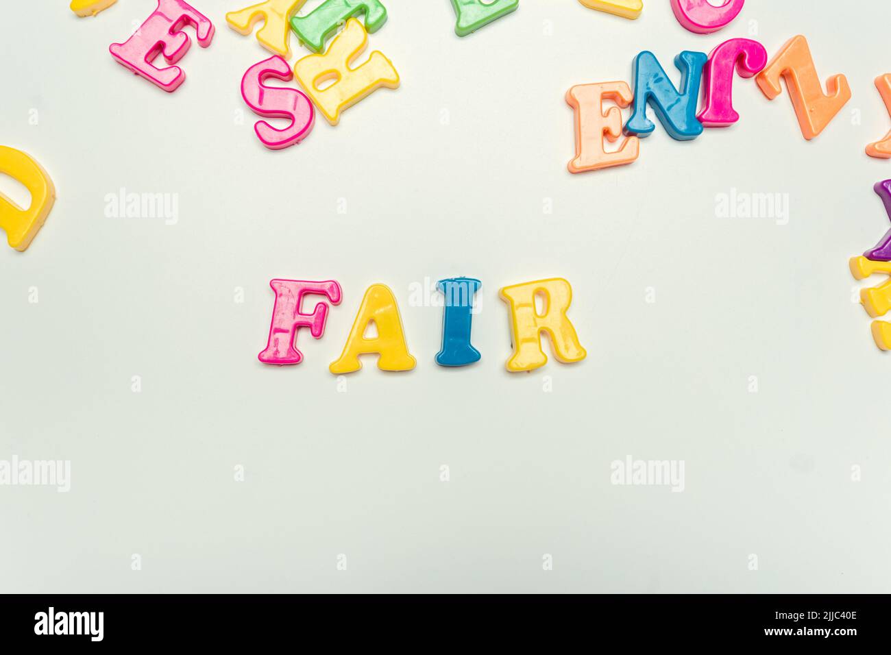 Plastic colorful letters with the text: Fair close up Stock Photo - Alamy