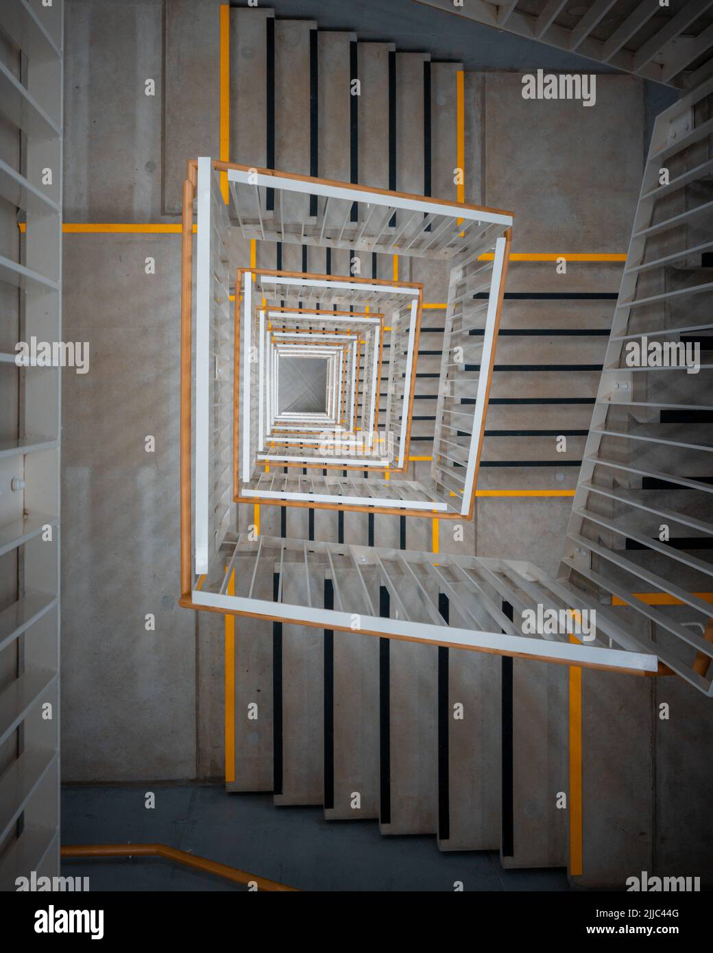 A vertical top view of rectangular staircase with white and orange ...