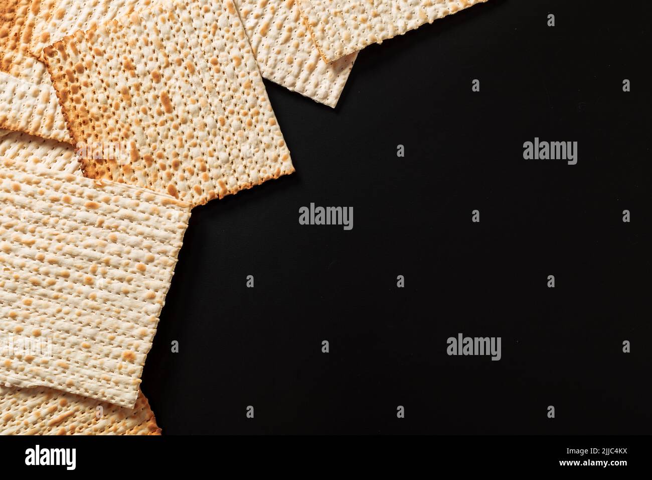 A photo of matzah or matza pieces on black background. Matzah for the ...
