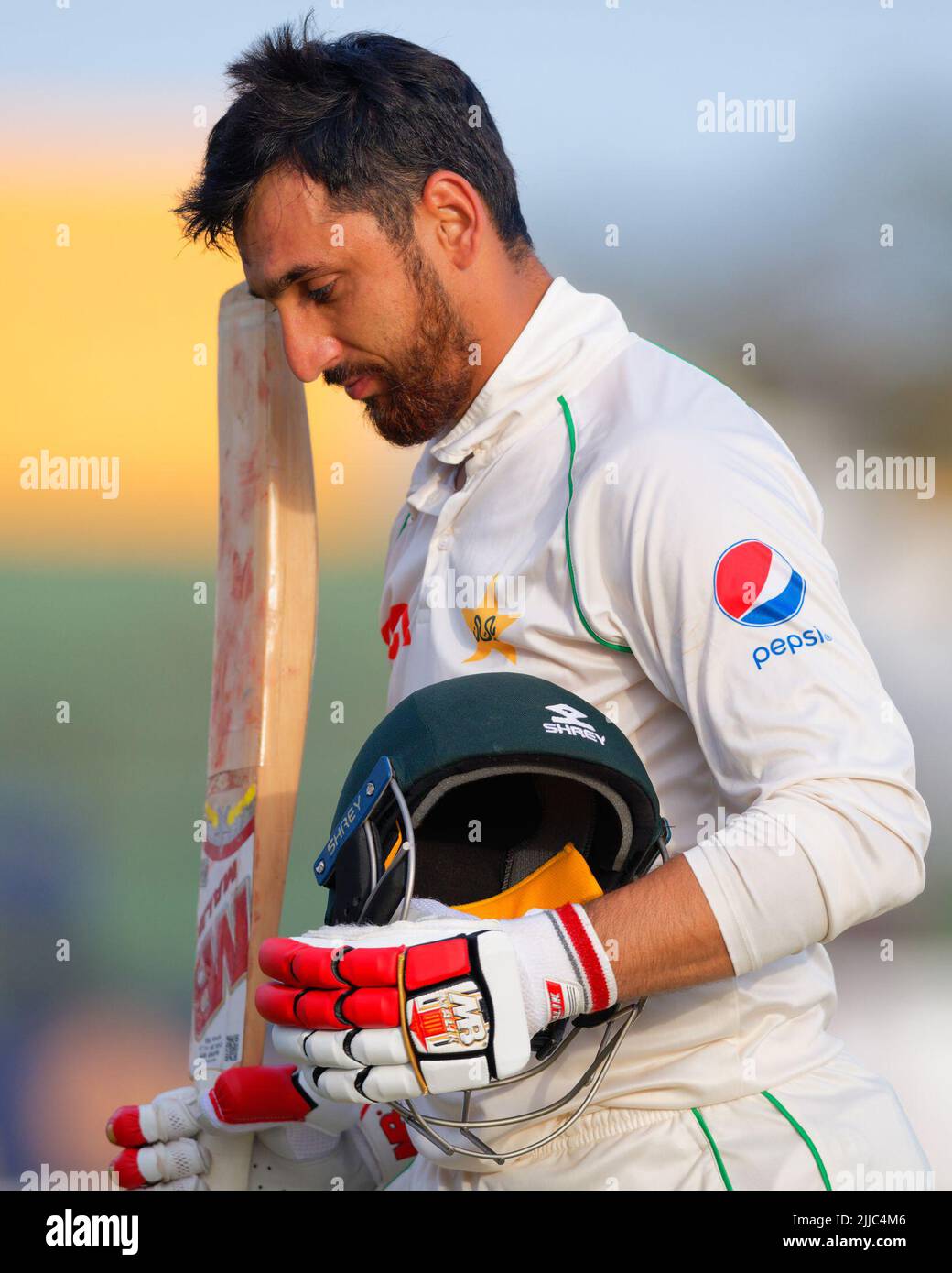 Galle, Sri Lanka. 25th July 2022. Pakistan's Agha Salman raises his bat ...