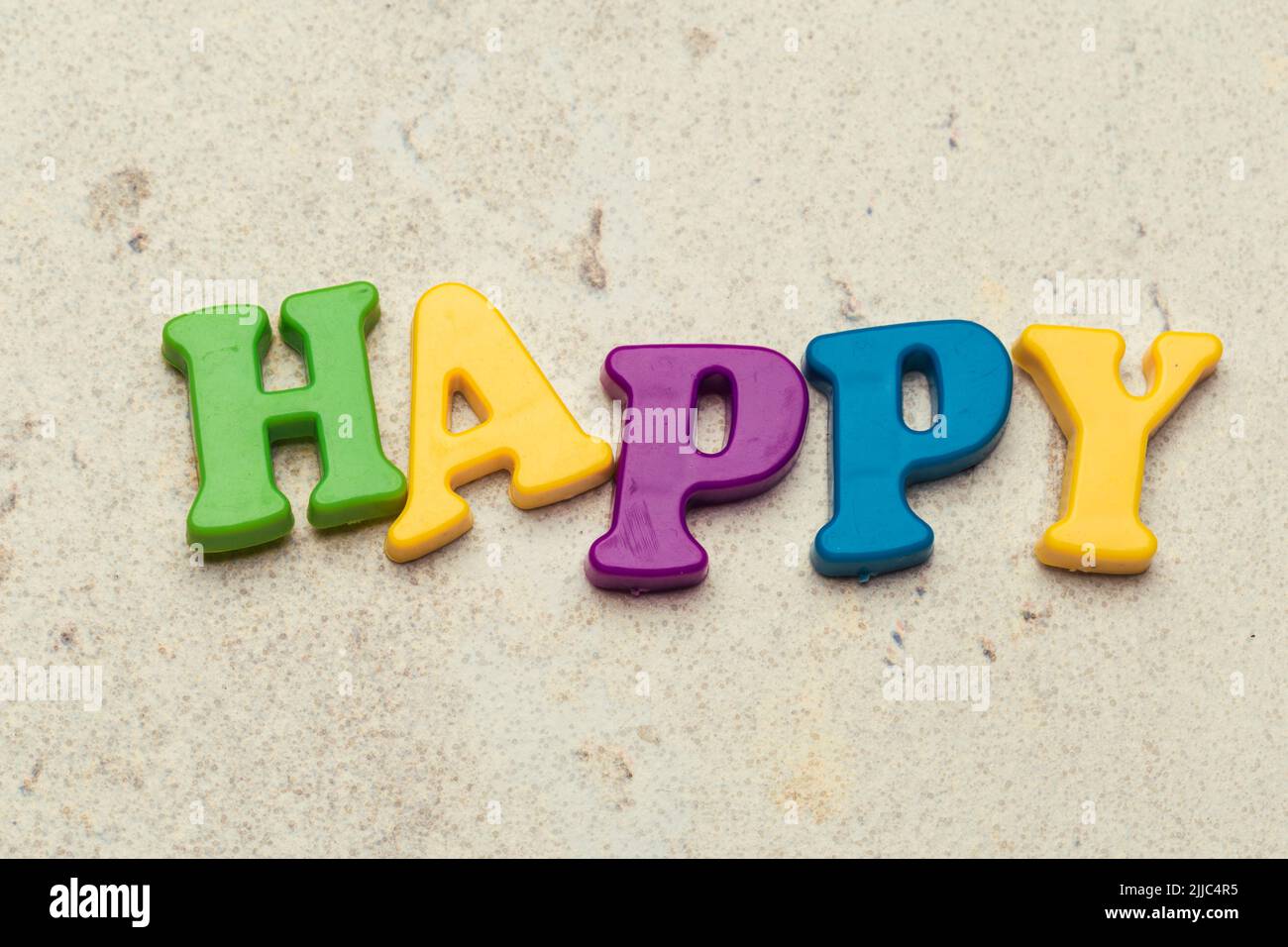 Word Happy written in colorful plastic letters close up shot Stock ...