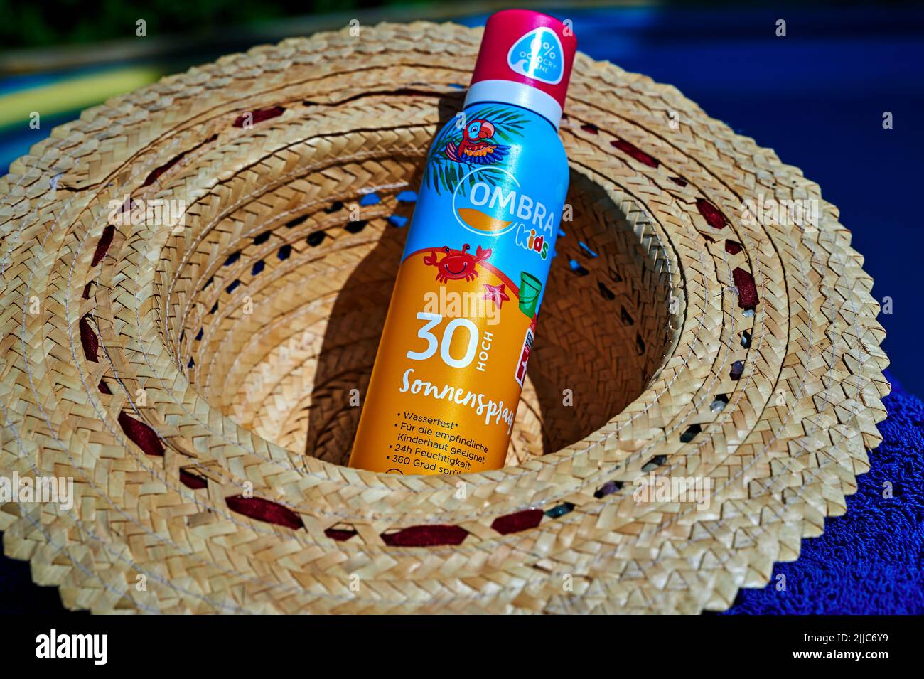 Berlin, Germany - July 24, 2022: Anti-sunburn spray on a blue towel by ...