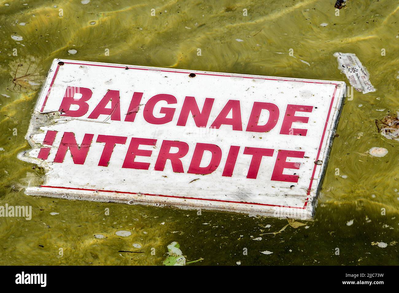 A swimming prohibited sign is seen floating on the surface of a pool in ...