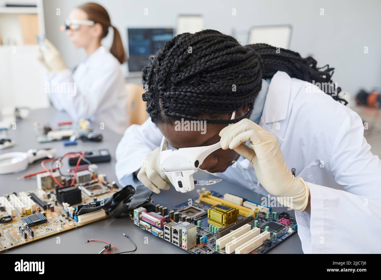 Portrait Of Black Of Female Engineer Inspecting Computer Parts In