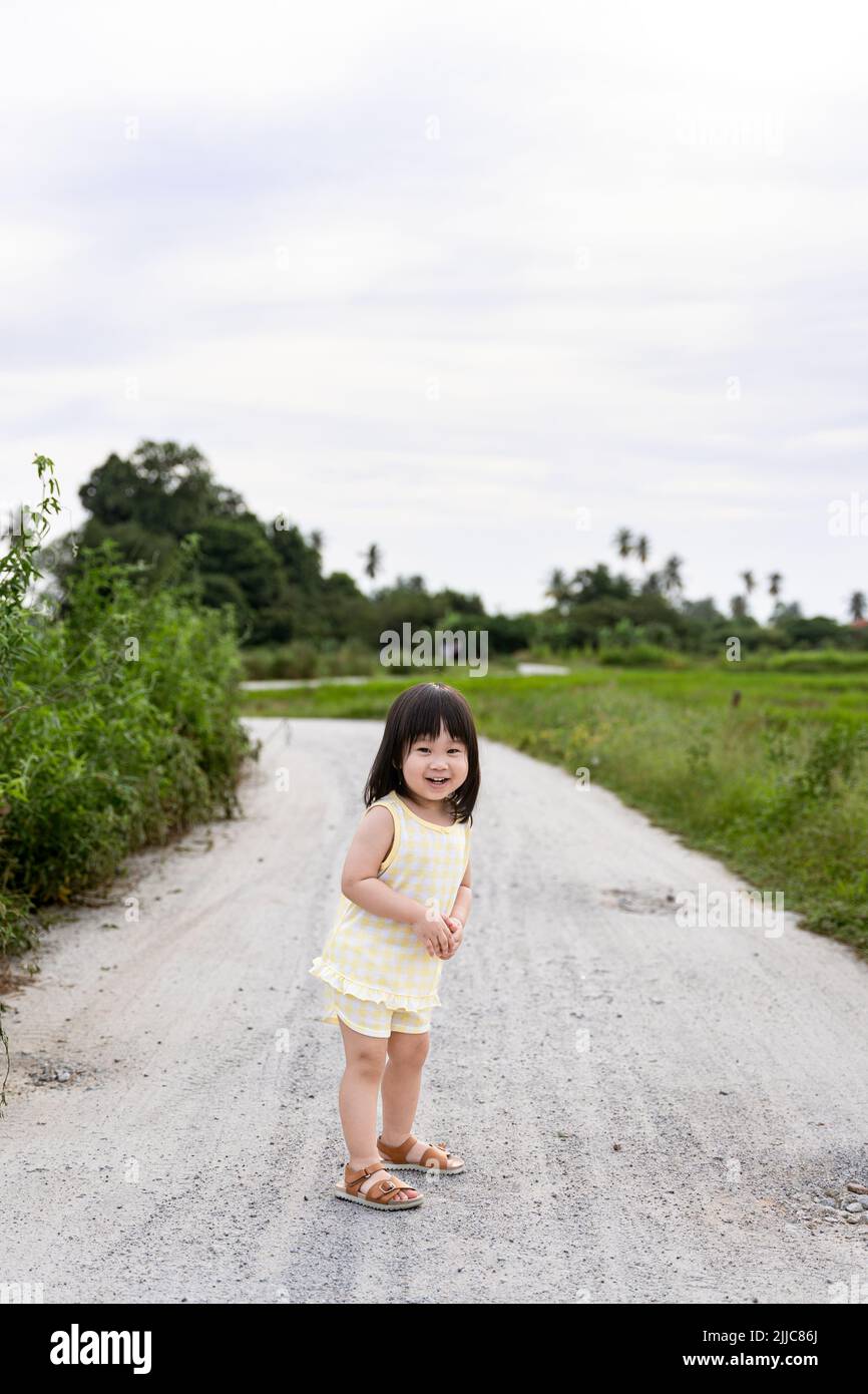 Cute little girl exploring the nature of paddy field. Excited for the ...