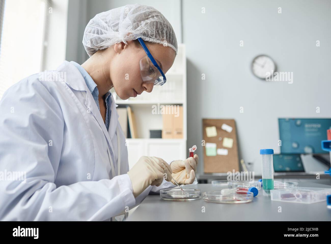 Side view portrait female lab technician doing experiments in medical ...