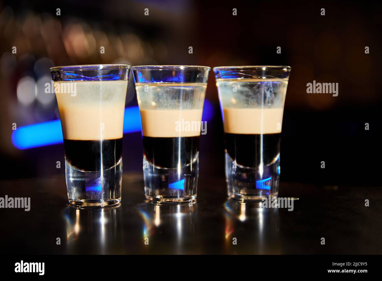 A set of shots b-52 from coffee liqueur, Irish cream and orange liqueur ...
