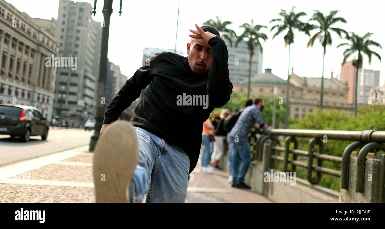 Happy hispanic man dancing celebrating in downtown city Stock Photo - Alamy
