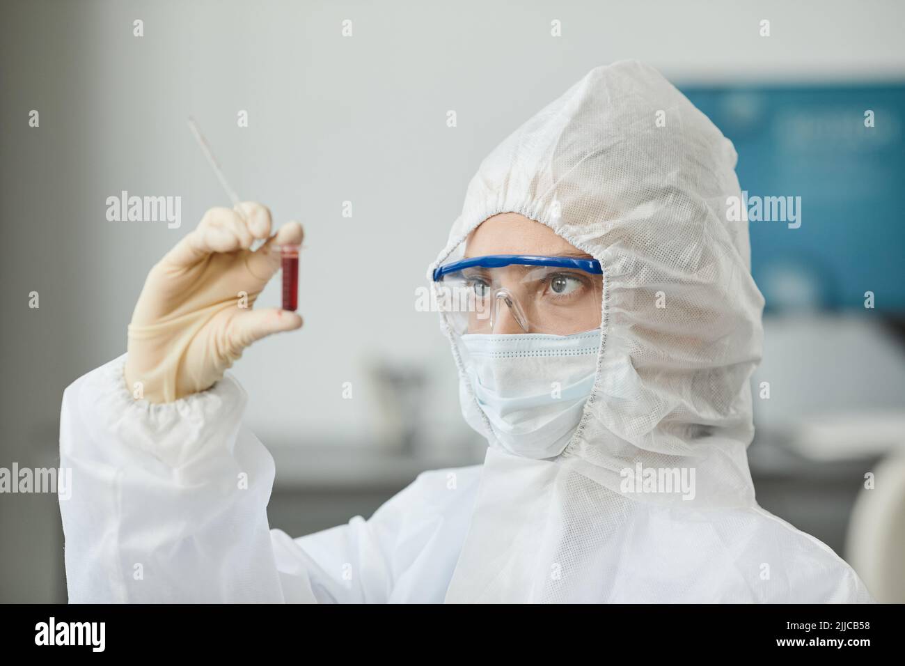 Side view portrait of two people wearing full protective gear analyzing ...