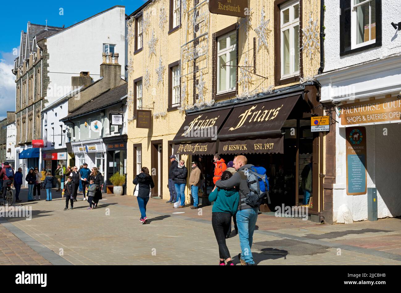 Shops stores people tourists visitors walkers in the town centre spring ...