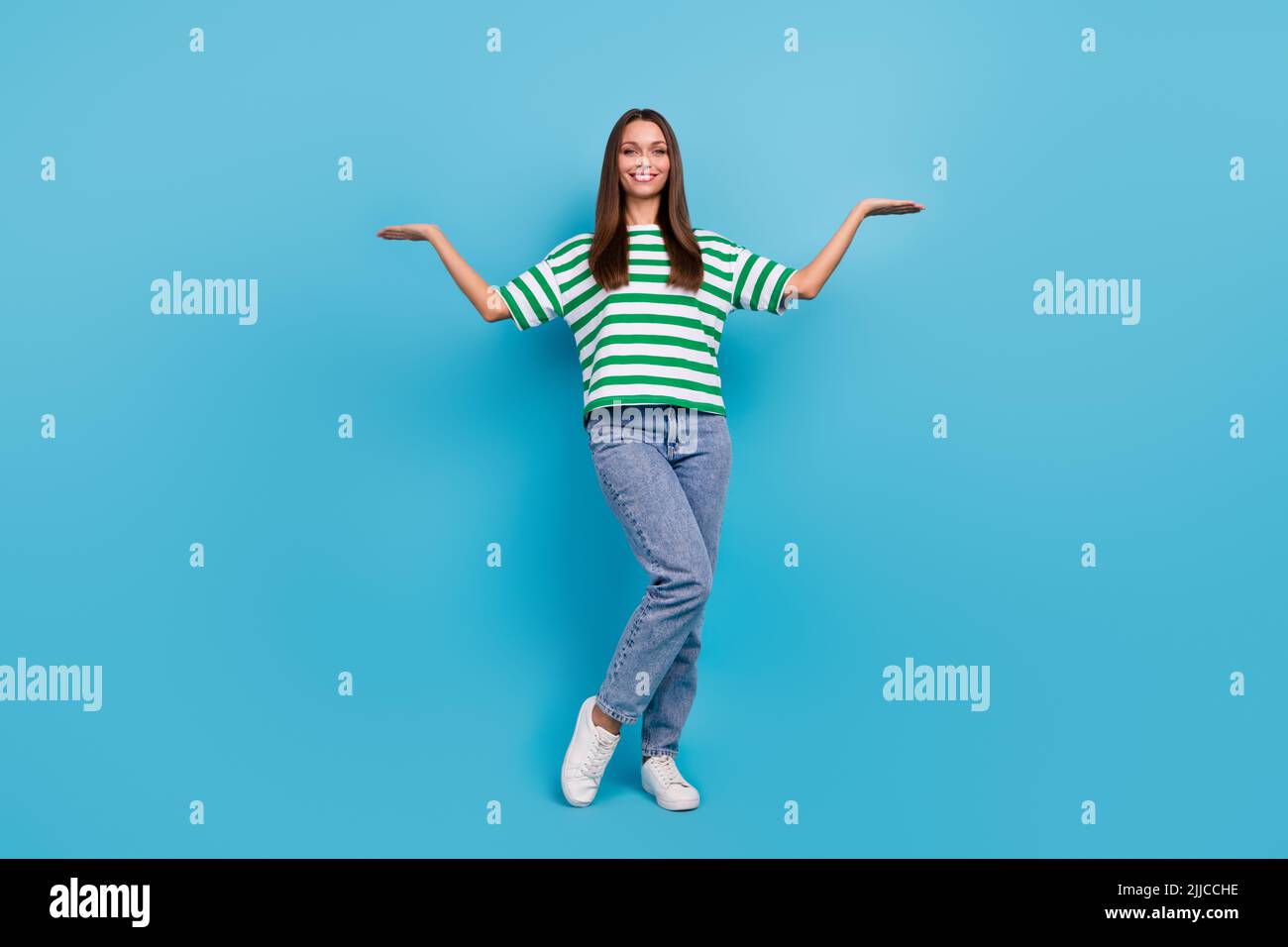 Full size photo of optimistic young lady hold empty space wear t-shirt ...