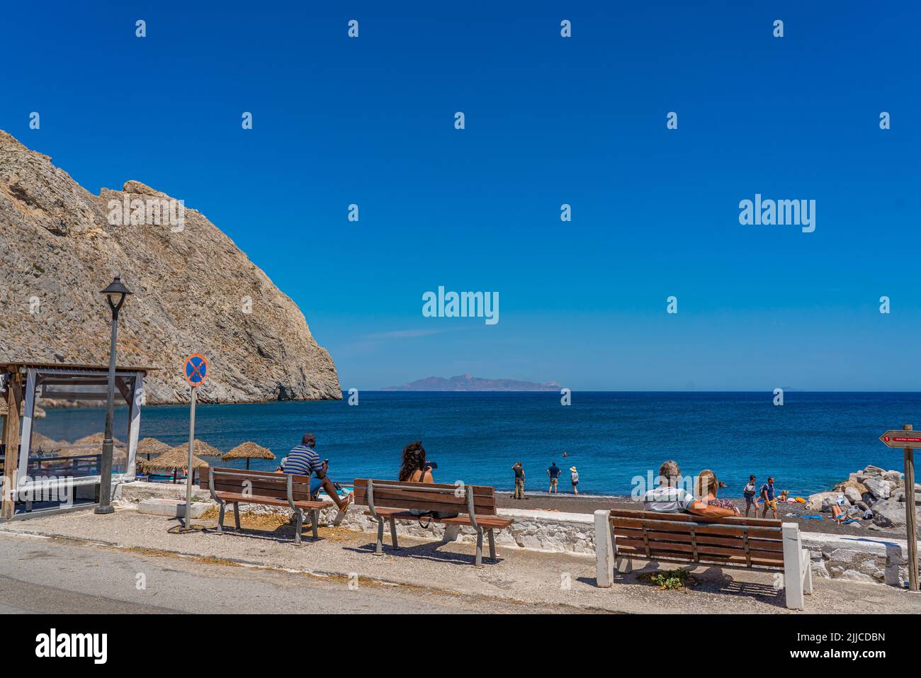 PERISSA, GREECE - MAY 22.2022: People looking to the black Perissa ...