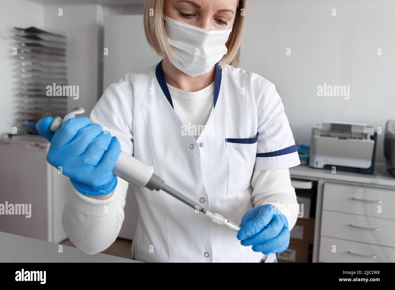 Worker of a laboratory of an hospital working with samples with a ...