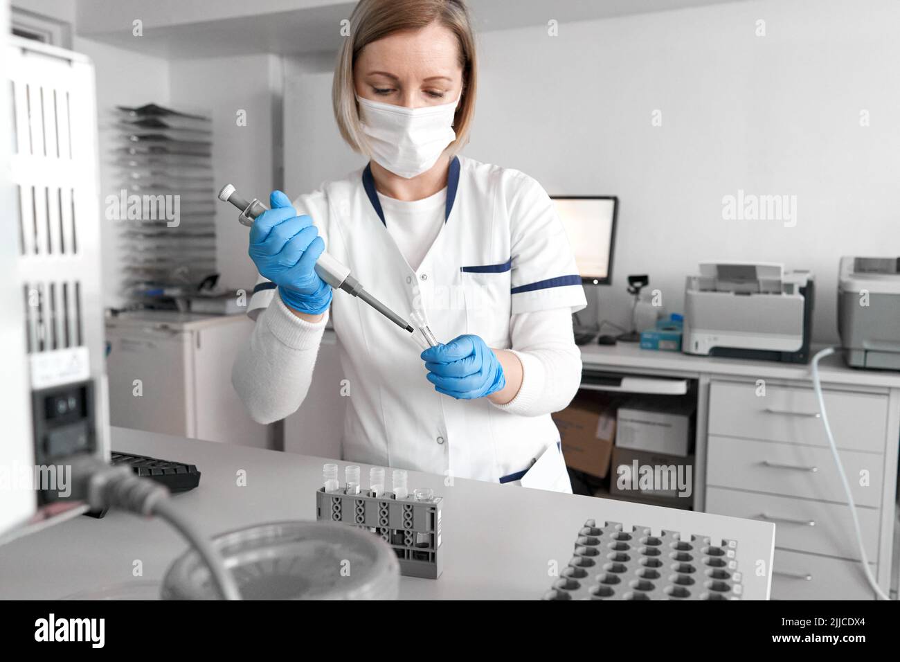 Laboratory technician working with samples and a centrifuge reaction ...