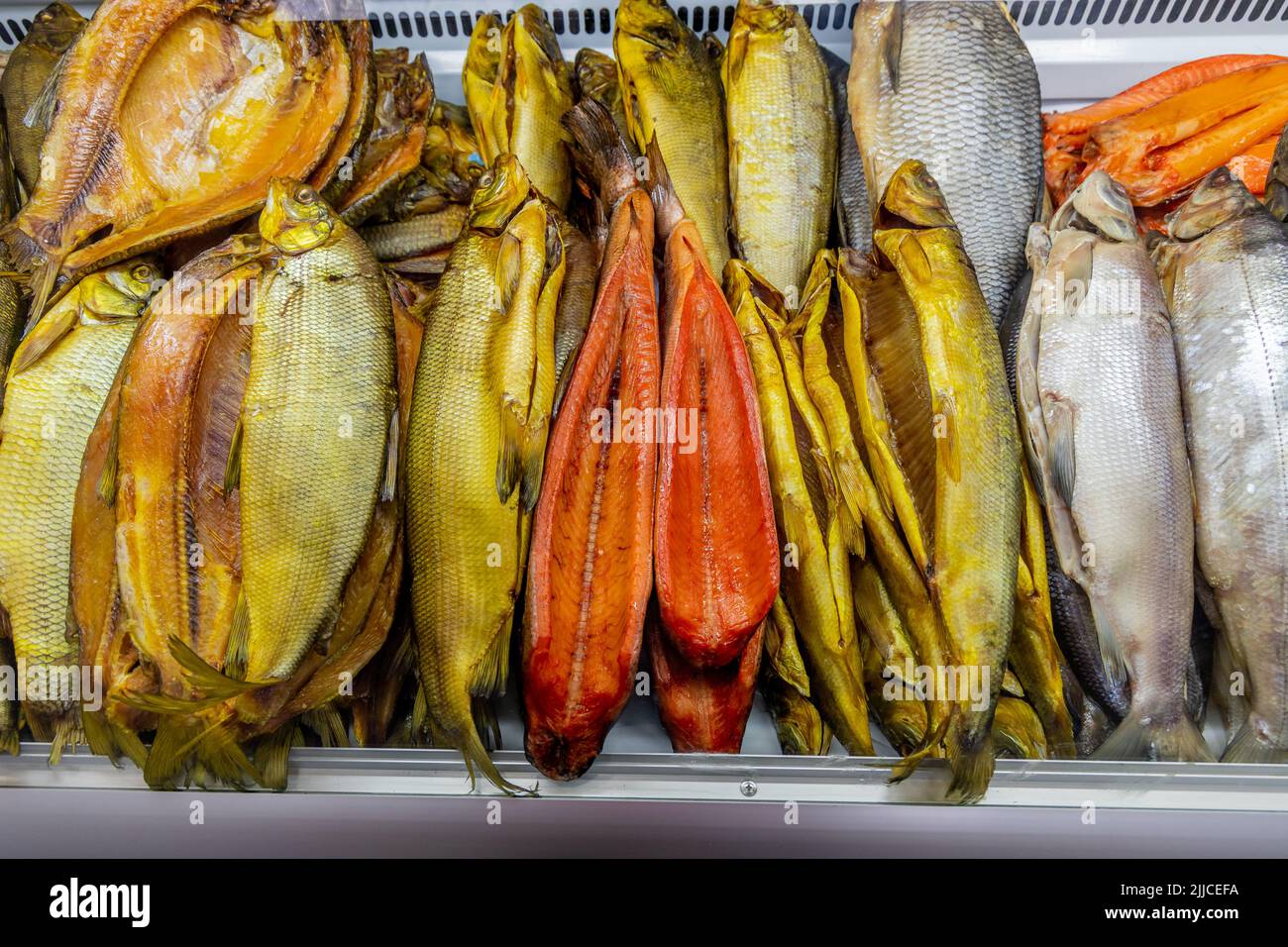 Salted fish and cold smoked fish on counter in store Stock Photo - Alamy