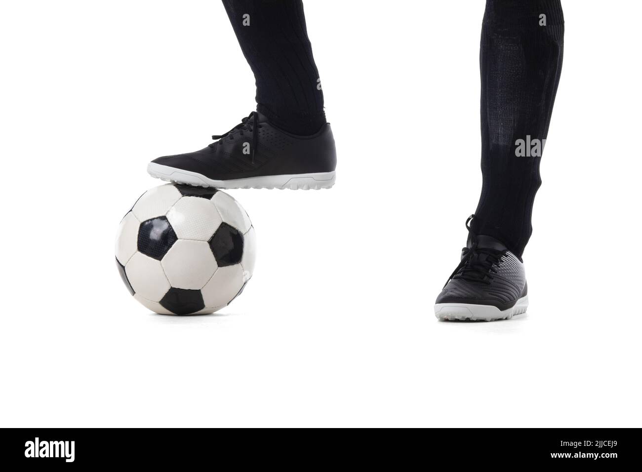 Legs of soccer player close-up and ball isolated on white background ...