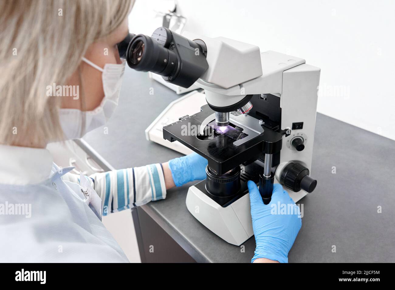 Scientist using a microscope in a laboratory of an hospital Stock Photo ...