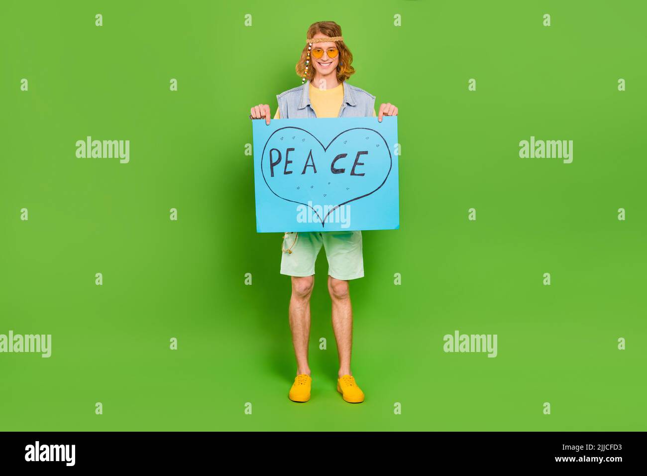 Full length body size view of attractive cheerful hippie guy holding ...