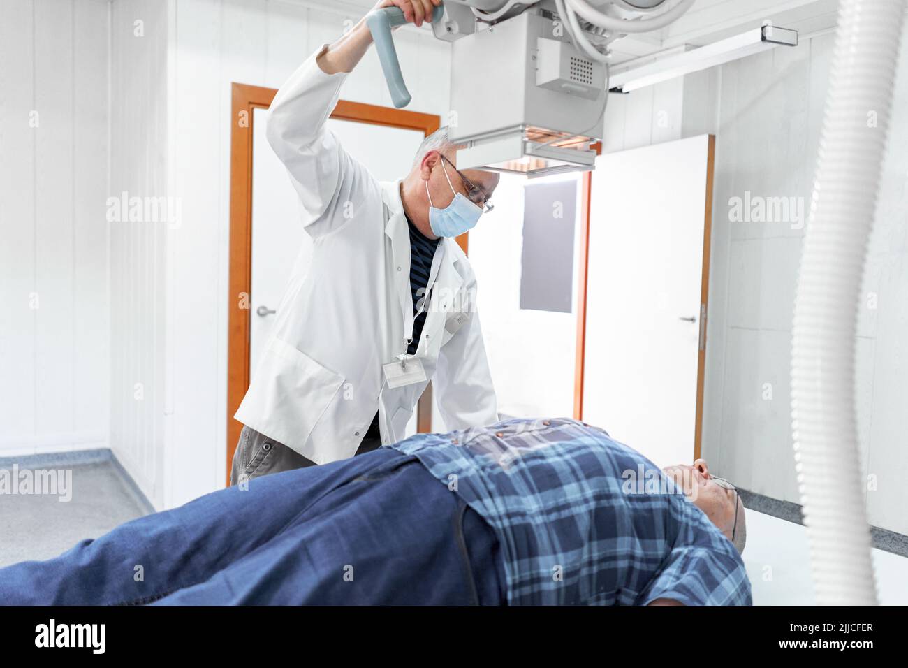 Specialist checking a patient using a x-ray machine in a hospital Stock ...