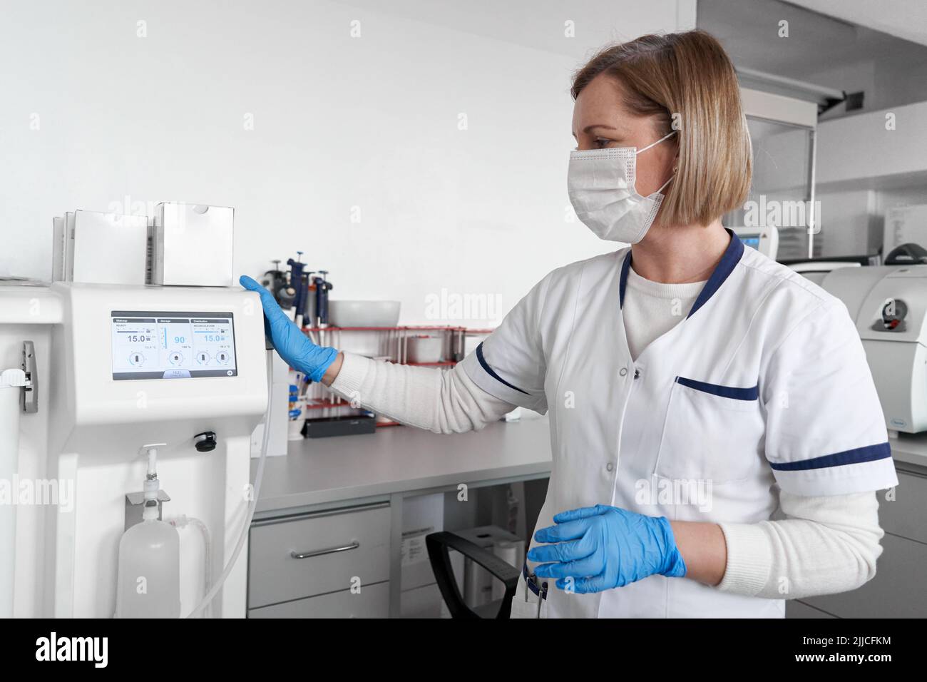 Doctor using medical equipment in an hospital office Stock Photo - Alamy