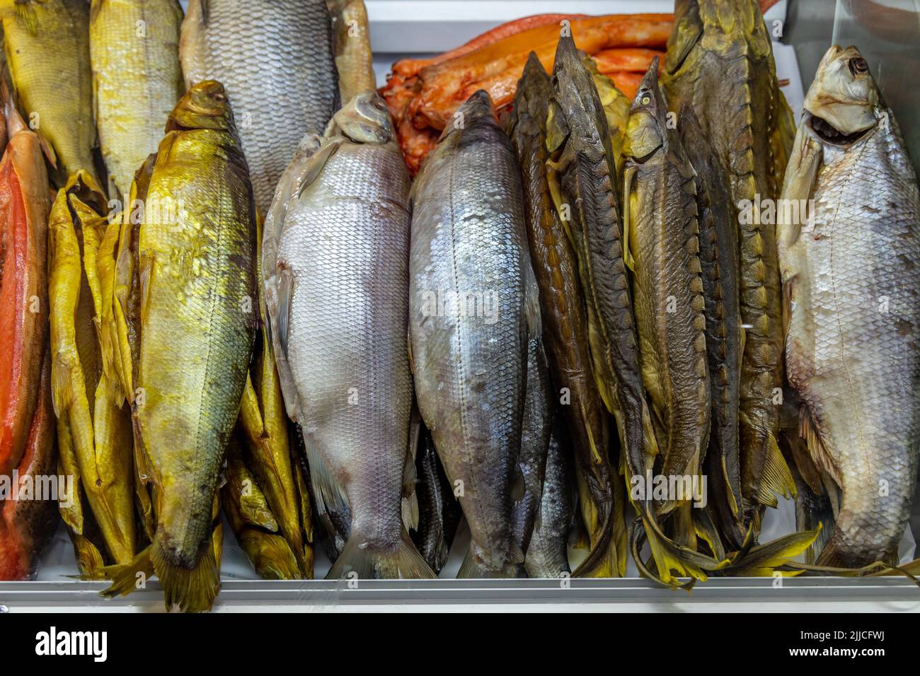 Salted fish and cold smoked fish on counter in store Stock Photo - Alamy