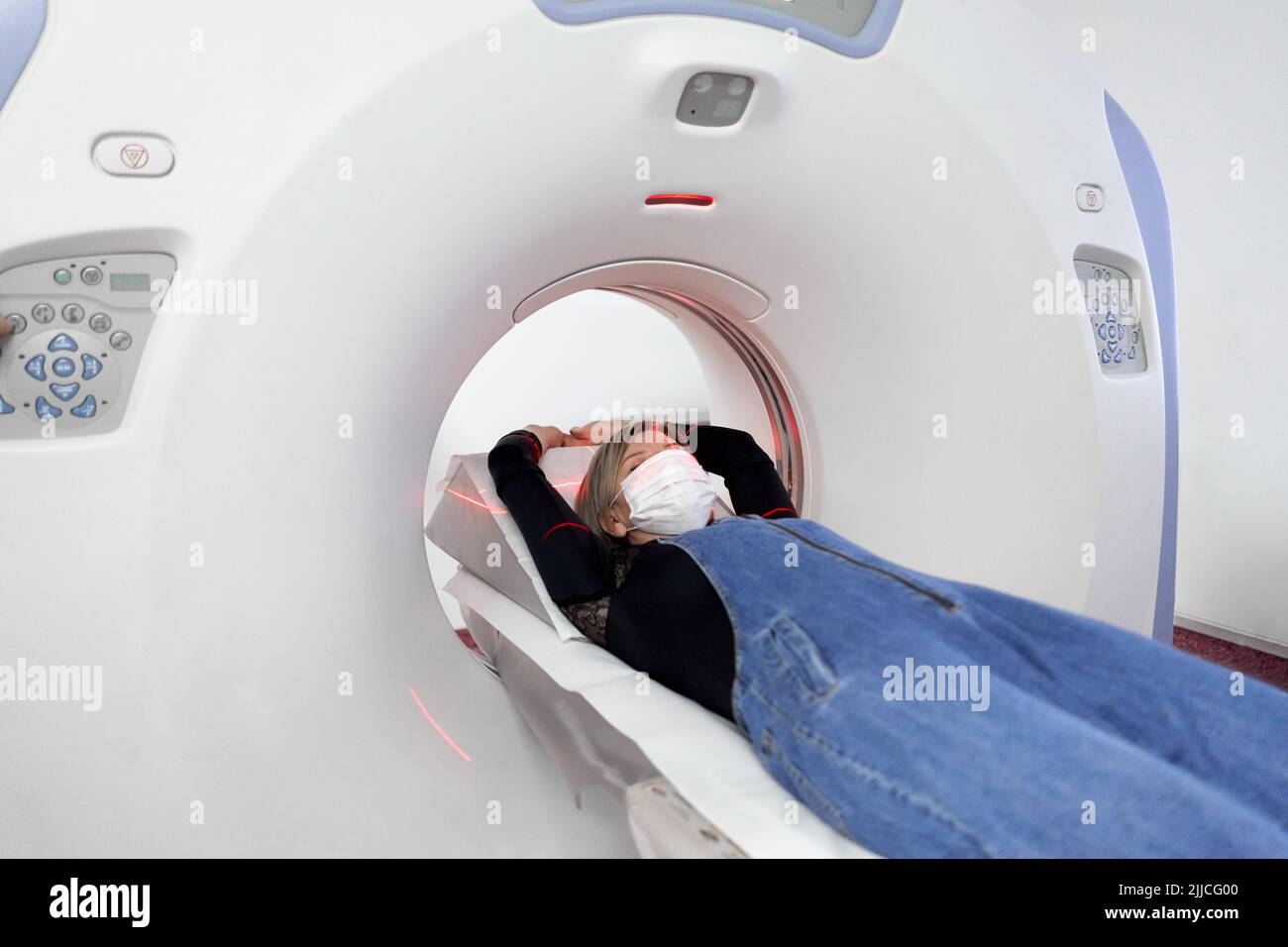 Patient wearing mask into a ct scan machine in an hospital Stock Photo ...