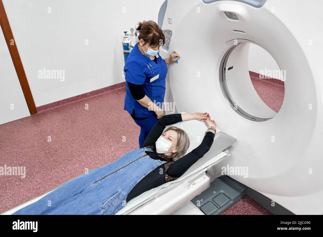 Patient lying on the stretcher of a tomography machine in a hospital ...
