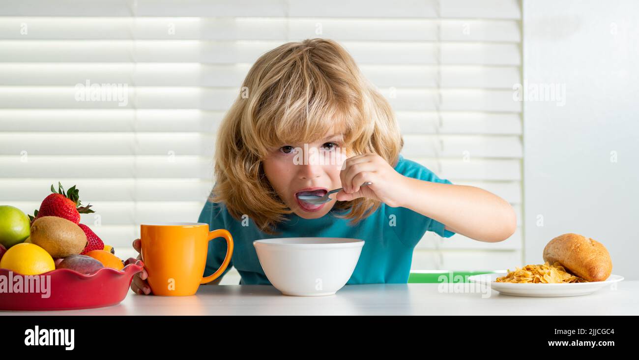 Hunger, appetite concept. Funny blonde little boy having breakfast ...