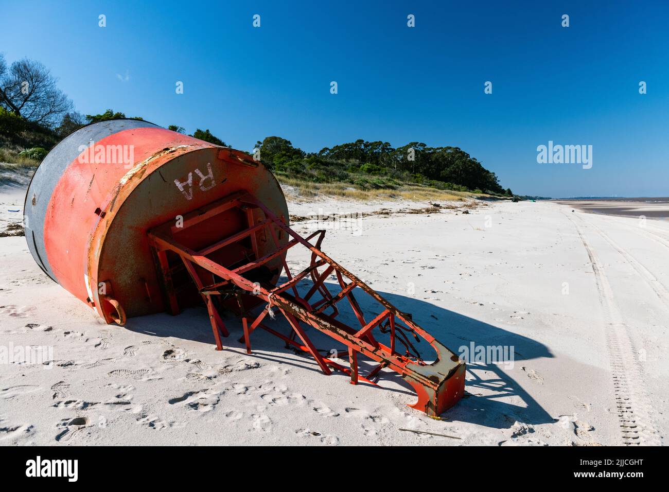 Old red and black signaling beacon stranded on the beach, Kiyu, San ...