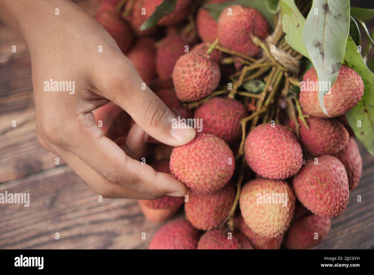 taking skin off a Lychee top down Stock Photo - Alamy