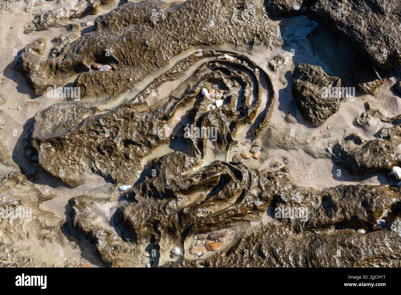 Empty beach where rock formations can be seen on the shore of the beach ...