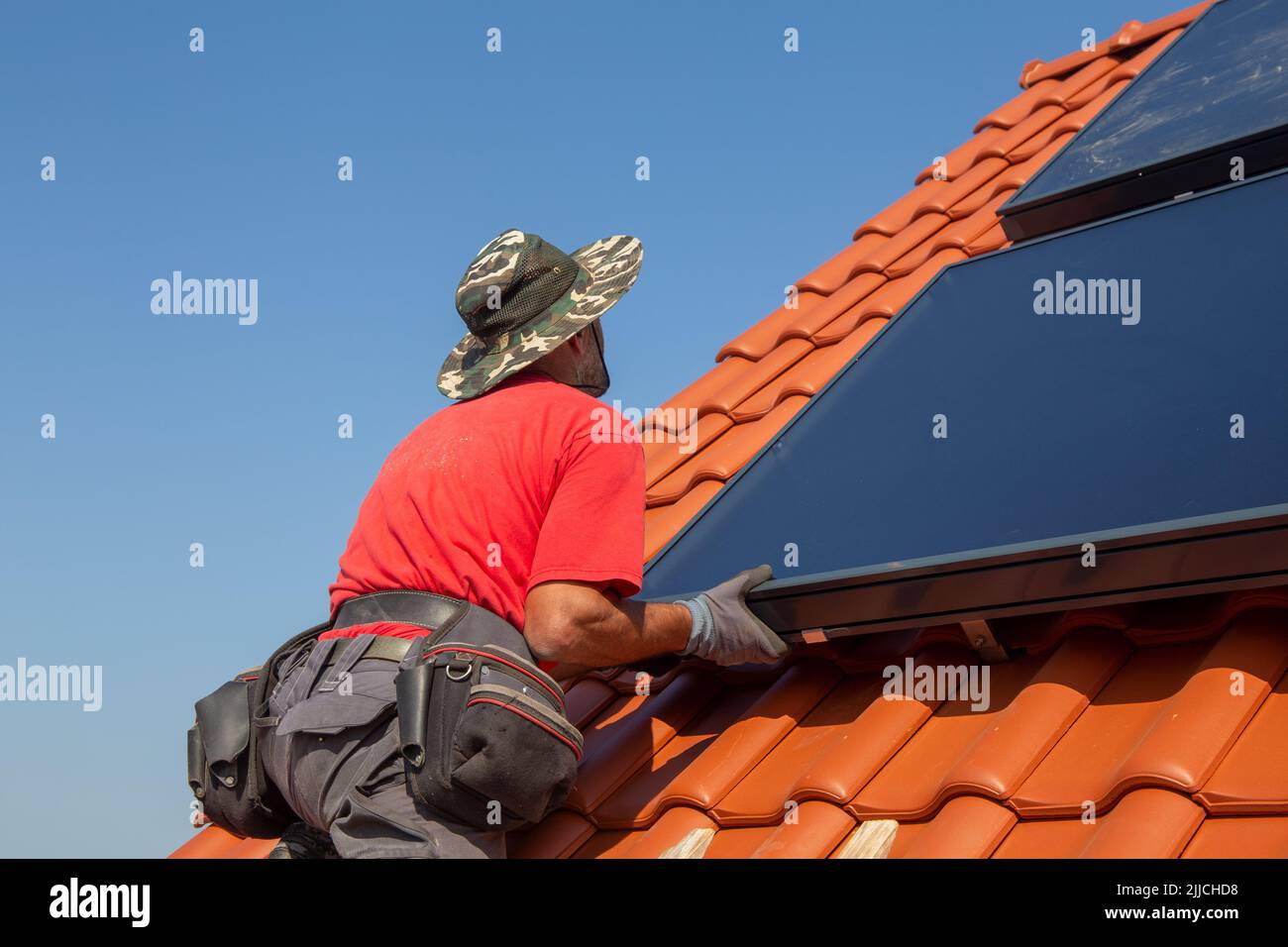 Installation of a solar system. Craftsmen attach the solar collectors ...