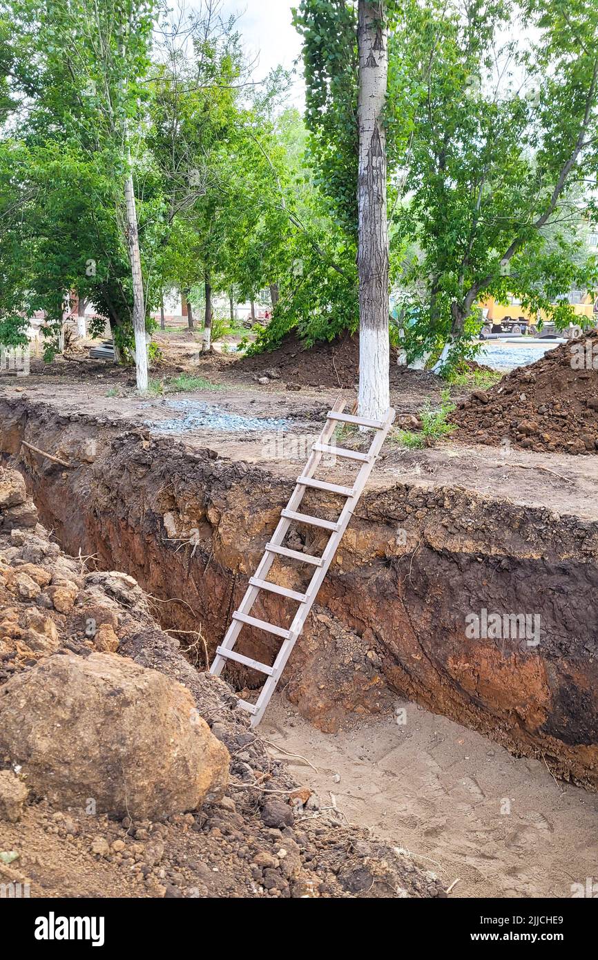 A wooden staircase stands deep pit dug for construction work Stock ...