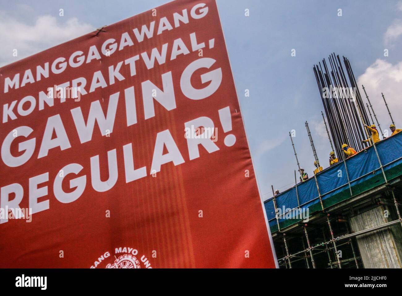 Construction workers are watching the demonstration from the top of the ...