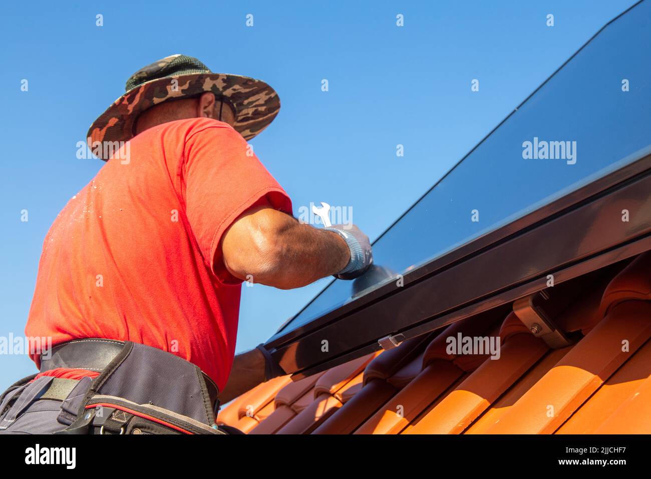 Installation of a solar system. Craftsmen attach the solar collectors ...