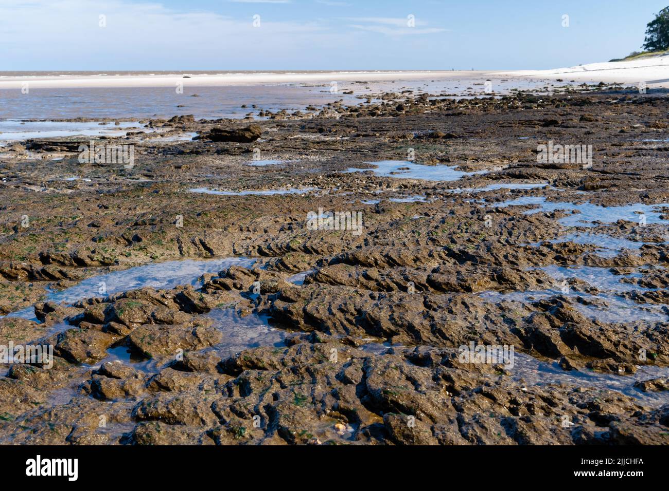Empty beach where rock formations can be seen on the shore of the beach ...
