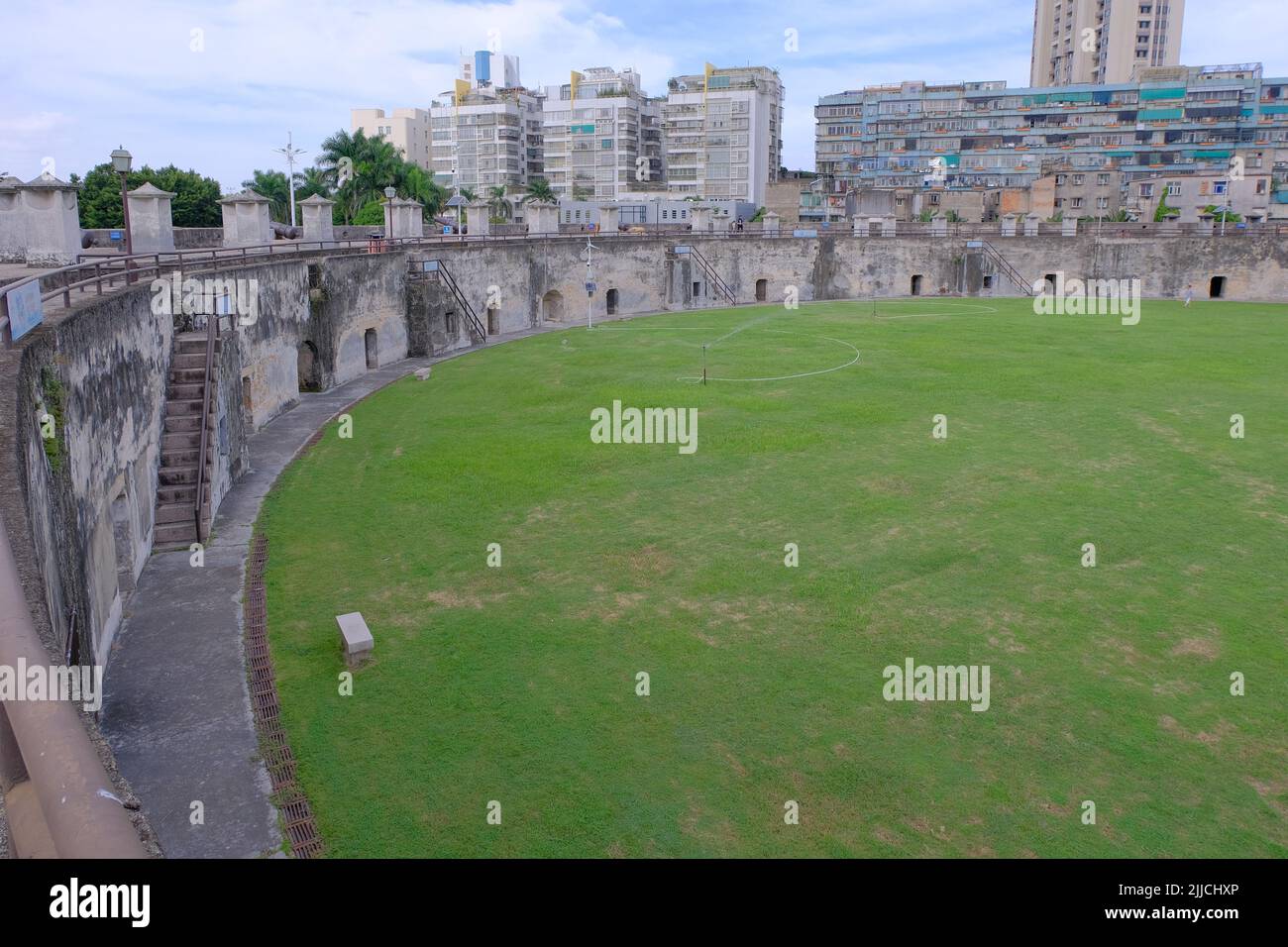 A green round shaped field with stone walls Stock Photo - Alamy