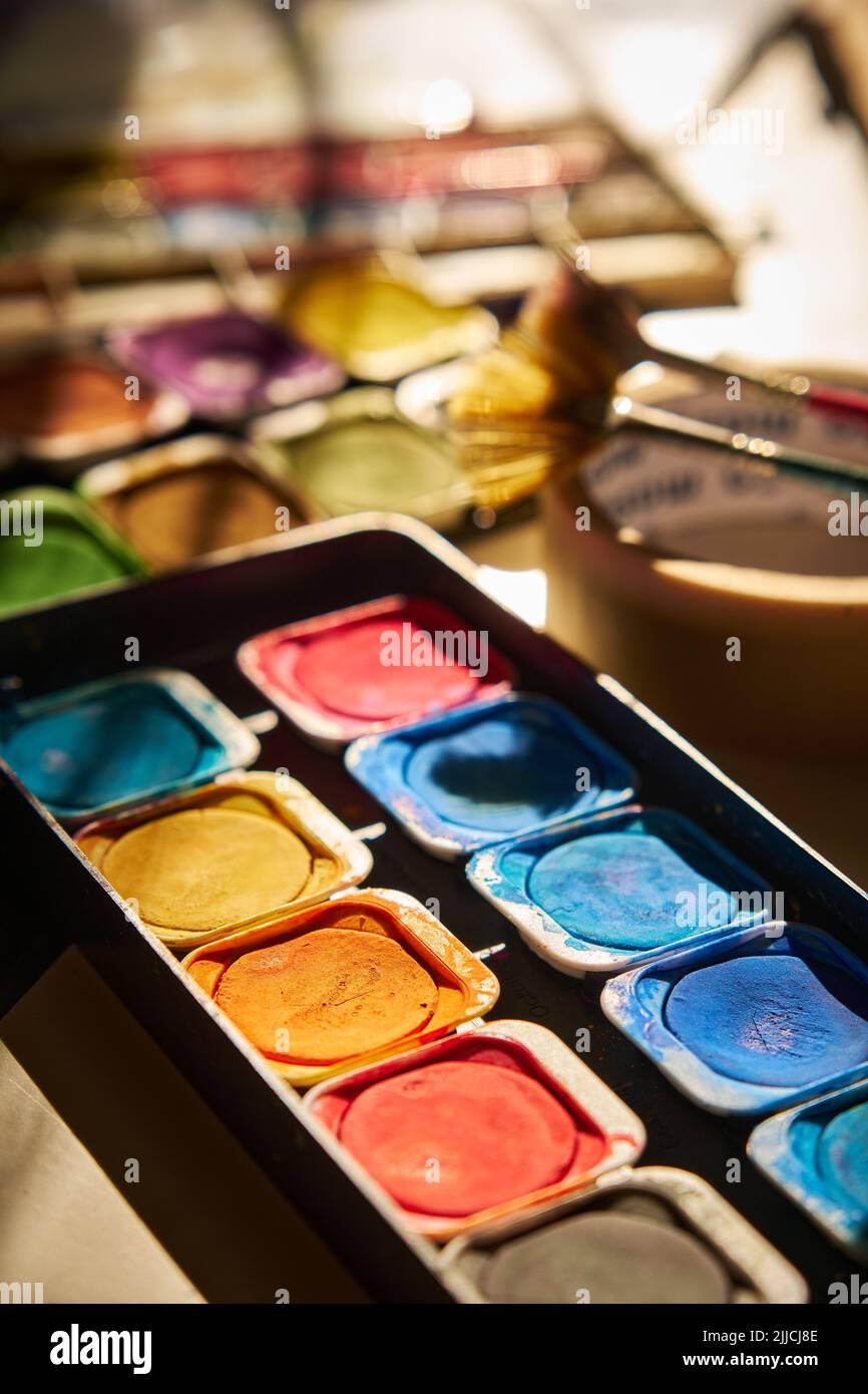 watercolor paints are laid out on the table in the sunlight Stock Photo ...