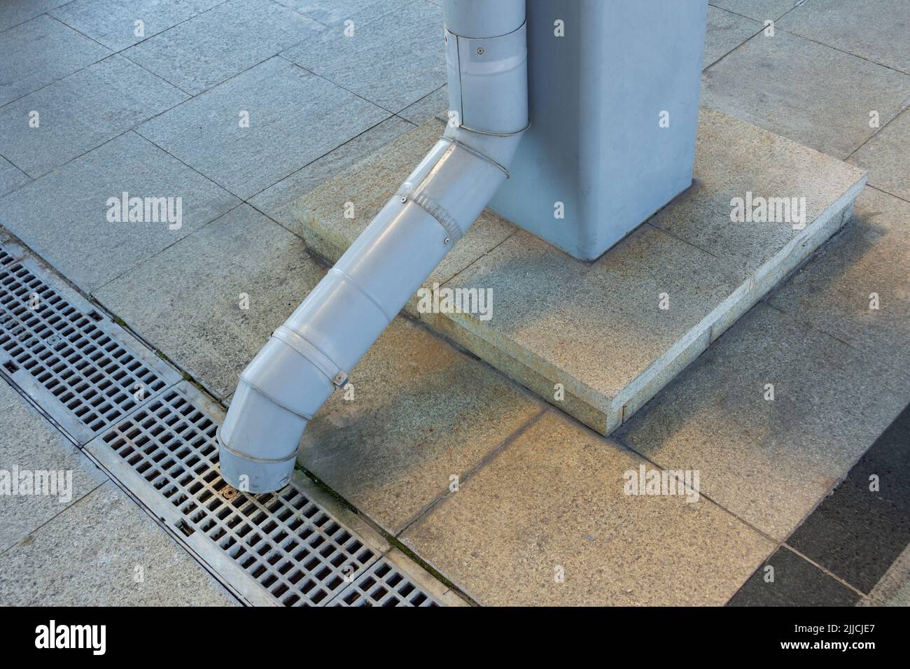 Metal drain pipe with a shoe for a drain pipe at the end. Fastened to a ...