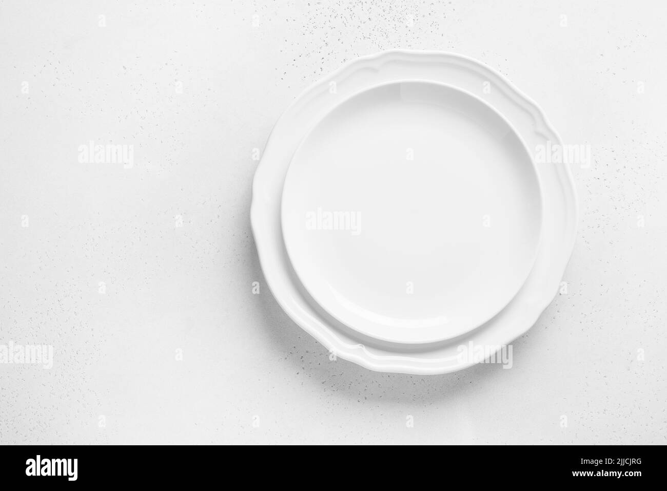 White empty plates on white culinary background. Kitchen and cooking ...