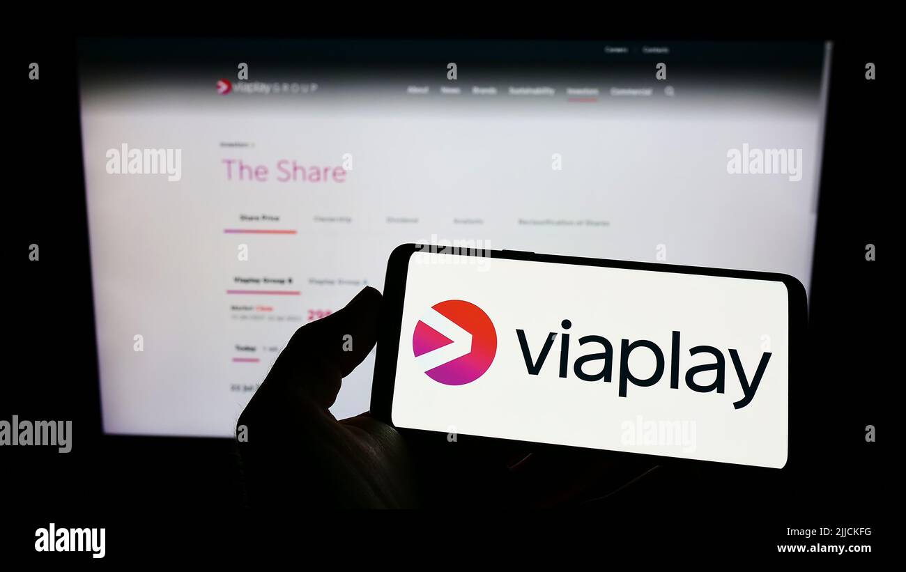 Person holding mobile phone with logo of Swedish media company Viaplay ...