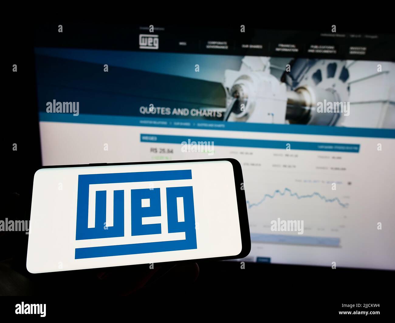 Person holding cellphone with logo of Brazilian company WEG ...