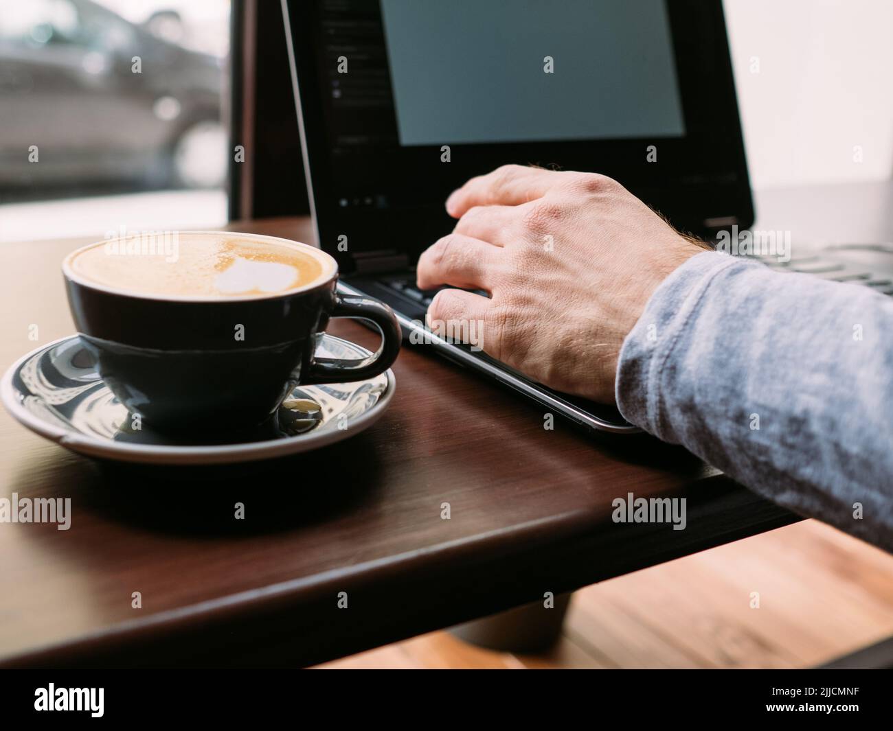 coffee break work man hands typing laptop cup Stock Photo - Alamy